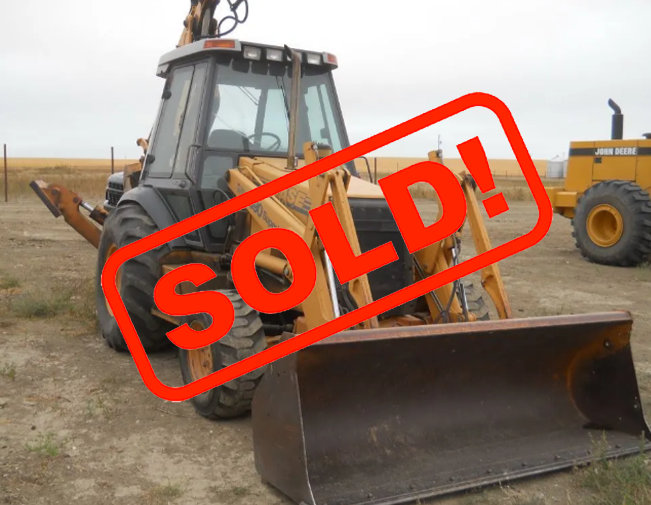 1997 Case 590 Super L - yellow and green machinery